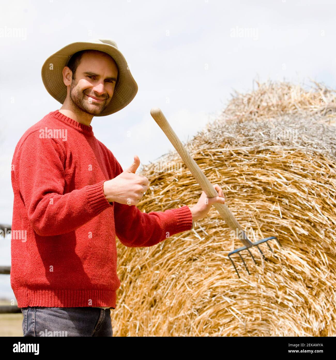 Man making a hay bale Stock Photo - Alamy