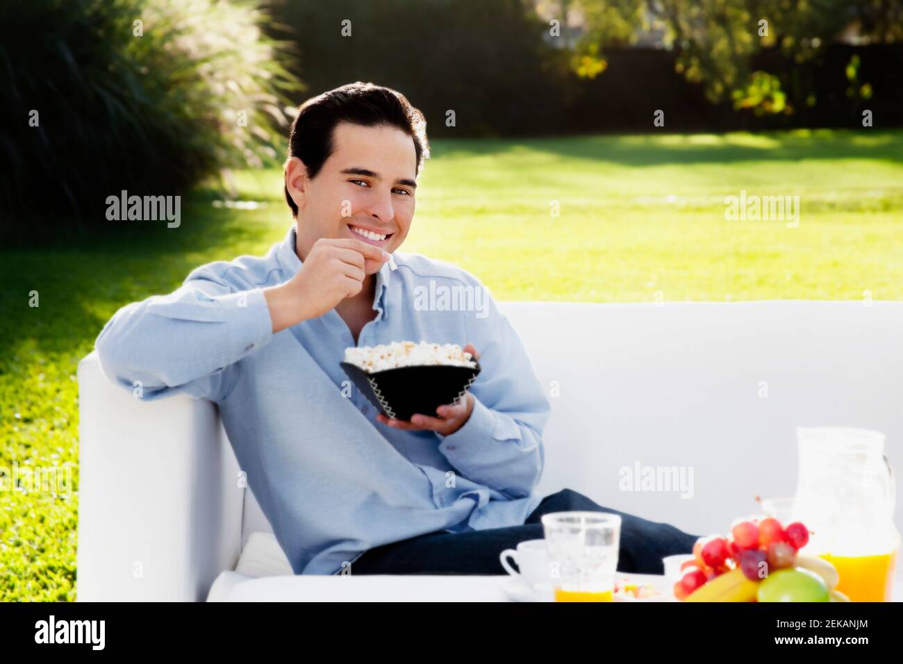 Portrait of a man eating popcorn Stock Photo - Alamy