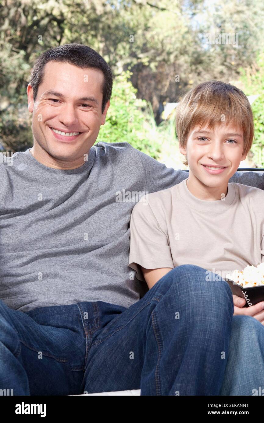 Portrait of a man smiling with his son Stock Photo - Alamy