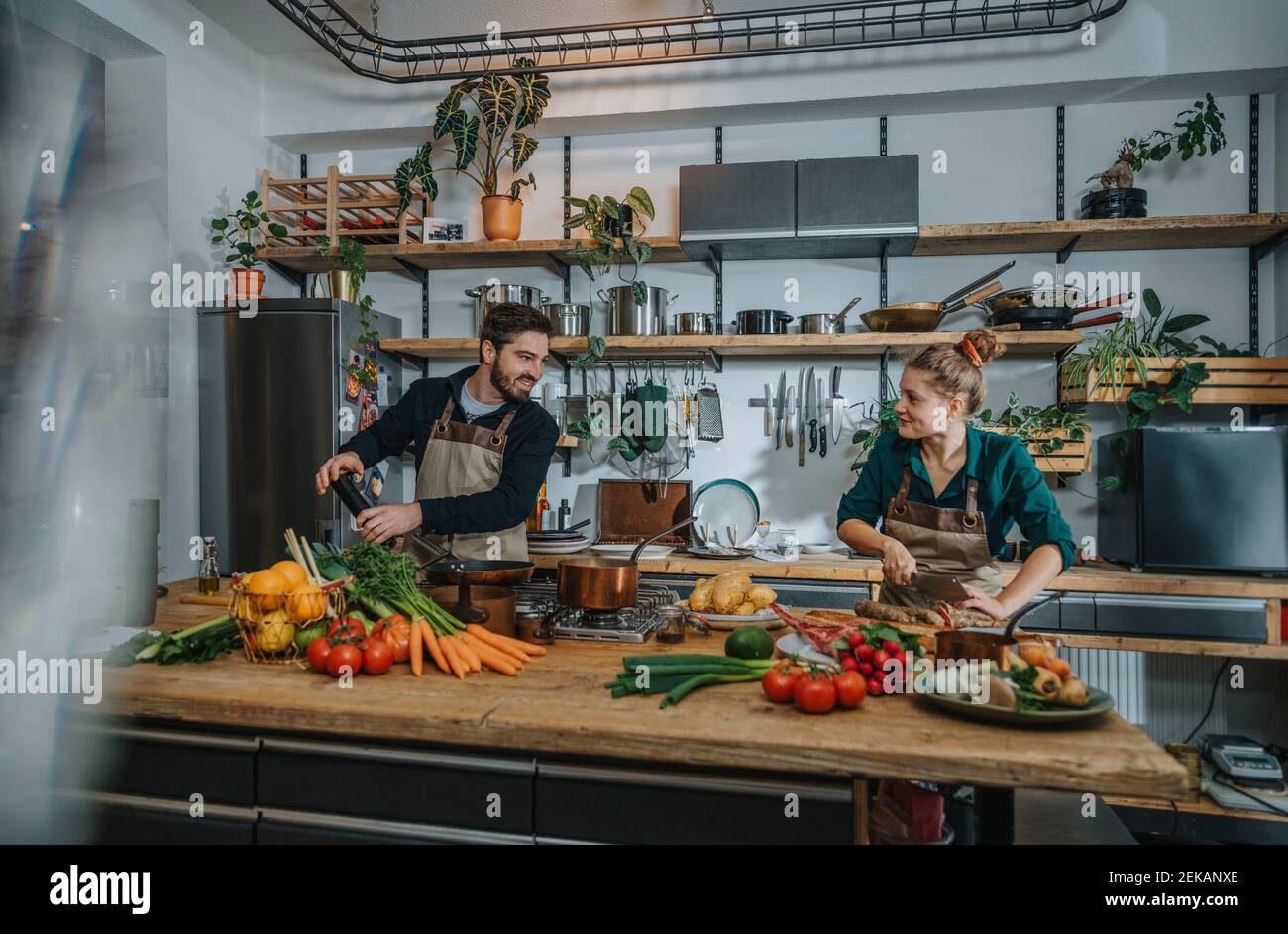 Chefs smiling while working in kitchen Stock Photo - Alamy