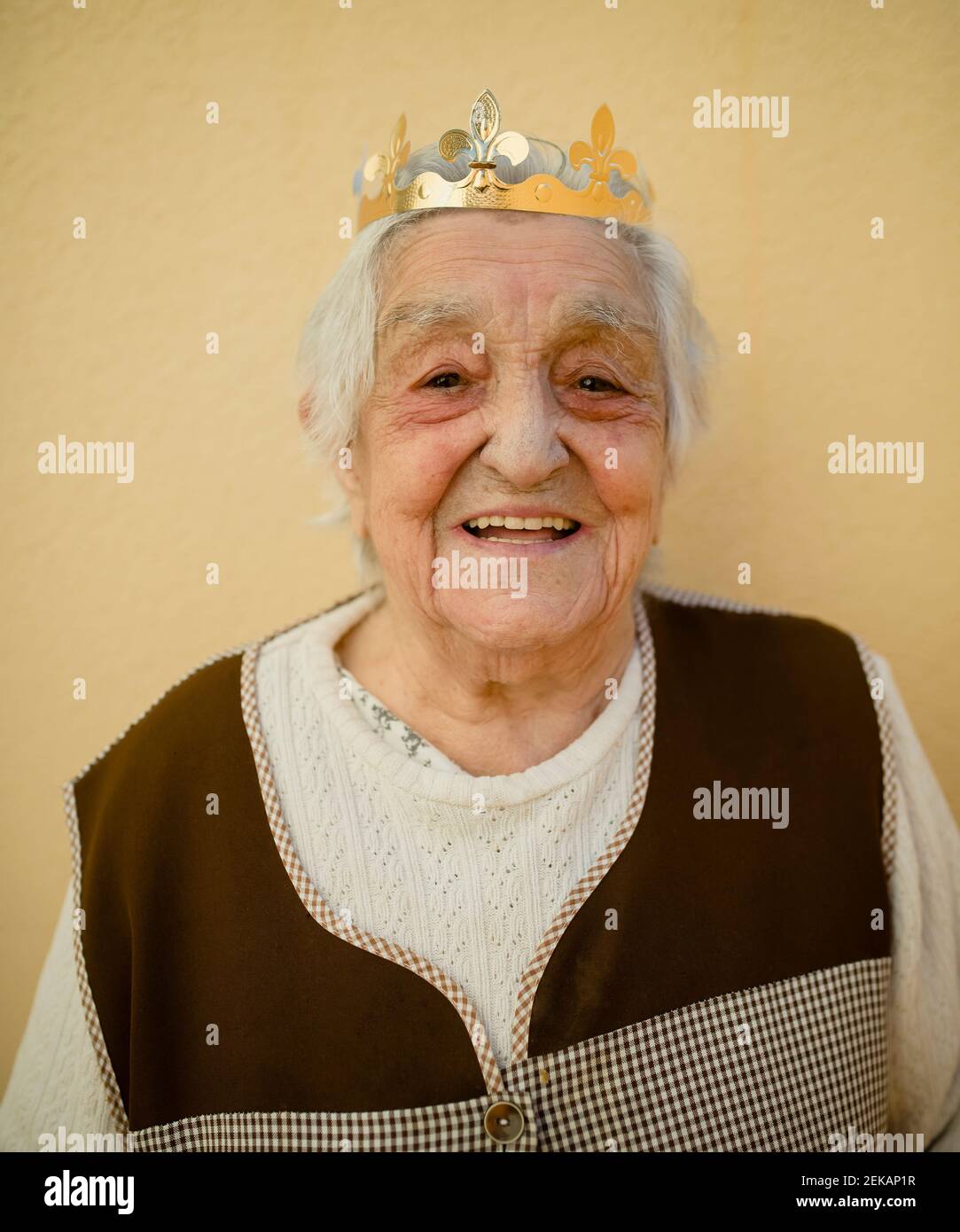 Close-up portrait of smiling senior woman wearing paper crown Stock ...