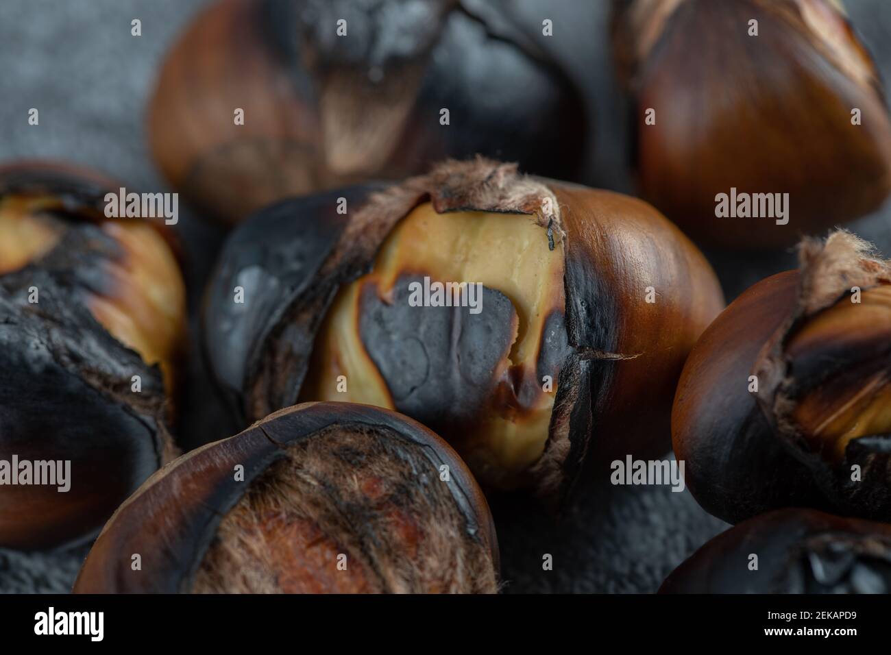 Delicious fried chestnuts on a gray background Stock Photo - Alamy