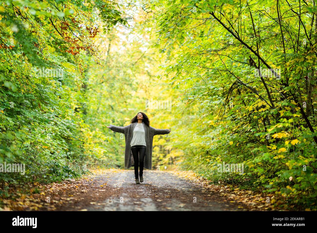 Woman arms outstretched running in hi-res stock photography and images ...