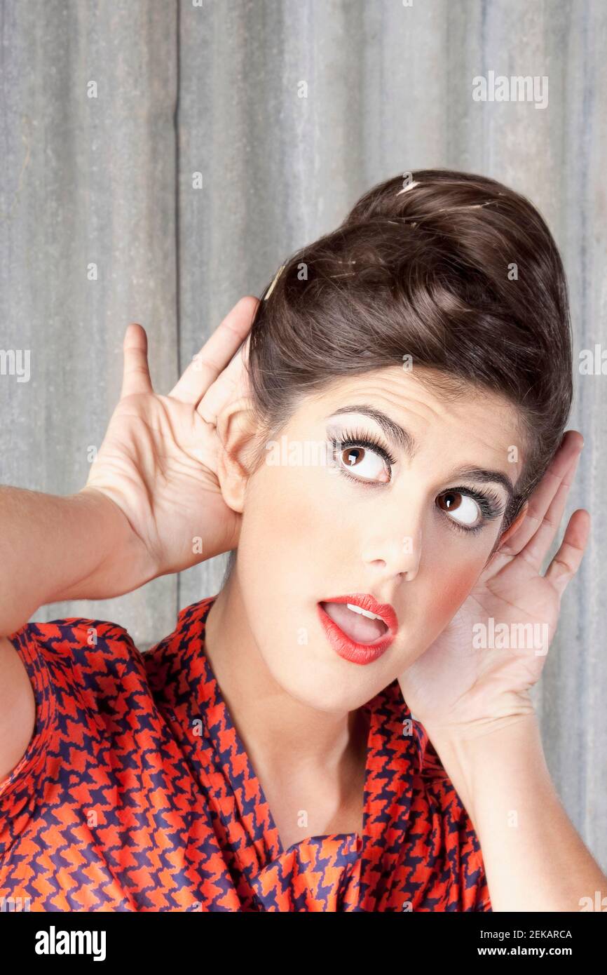 Close up of a woman cupping hands to ear Stock Photo - Alamy