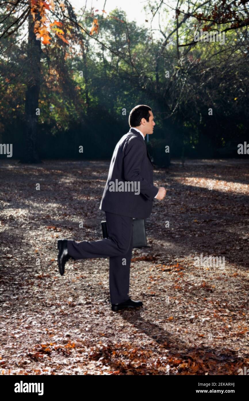 Man in suit running away hi-res stock photography and images - Alamy