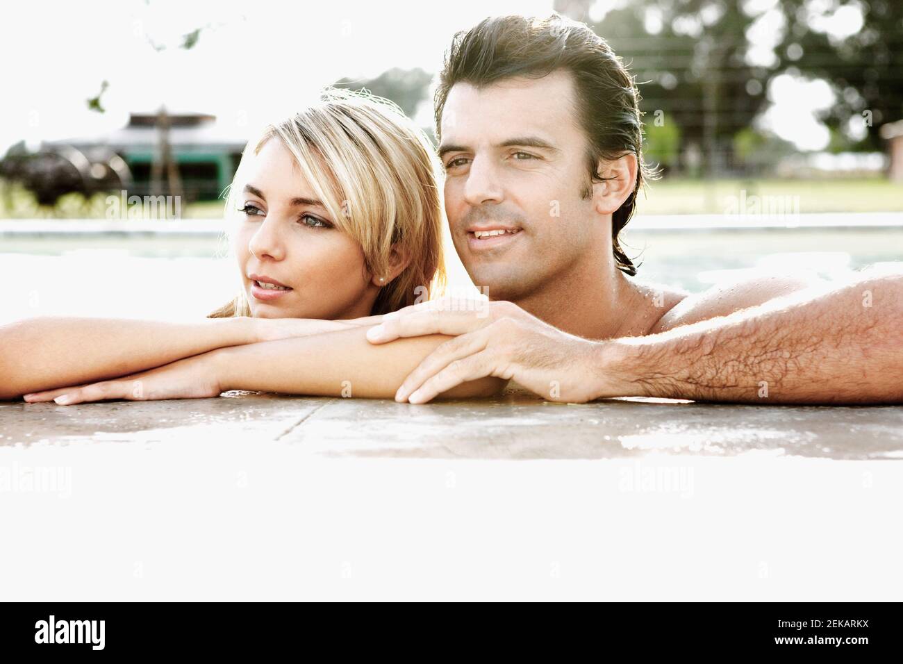 Couple smiling in a swimming pool Stock Photo - Alamy