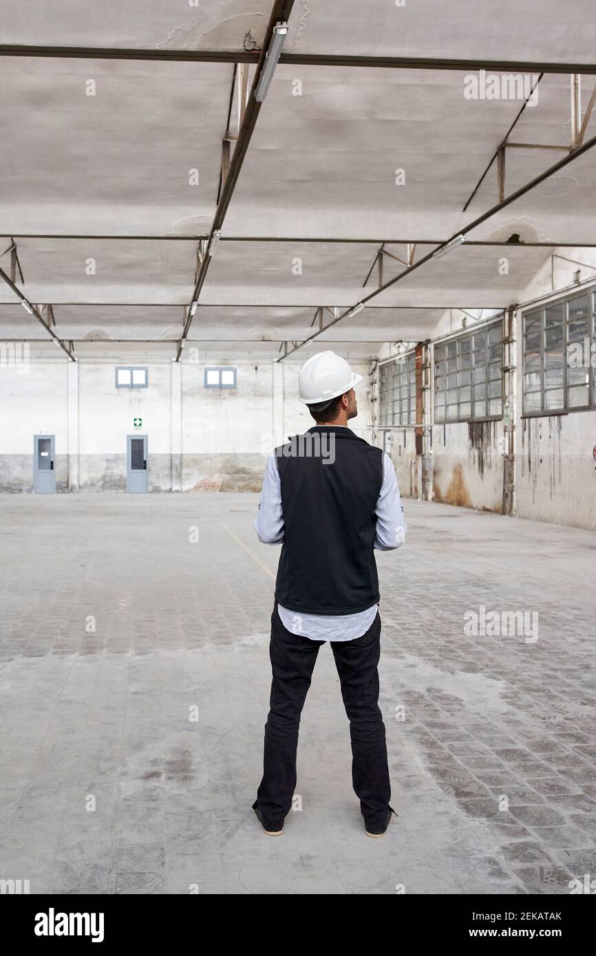 Male architect standing on floor in constructing building Stock Photo ...