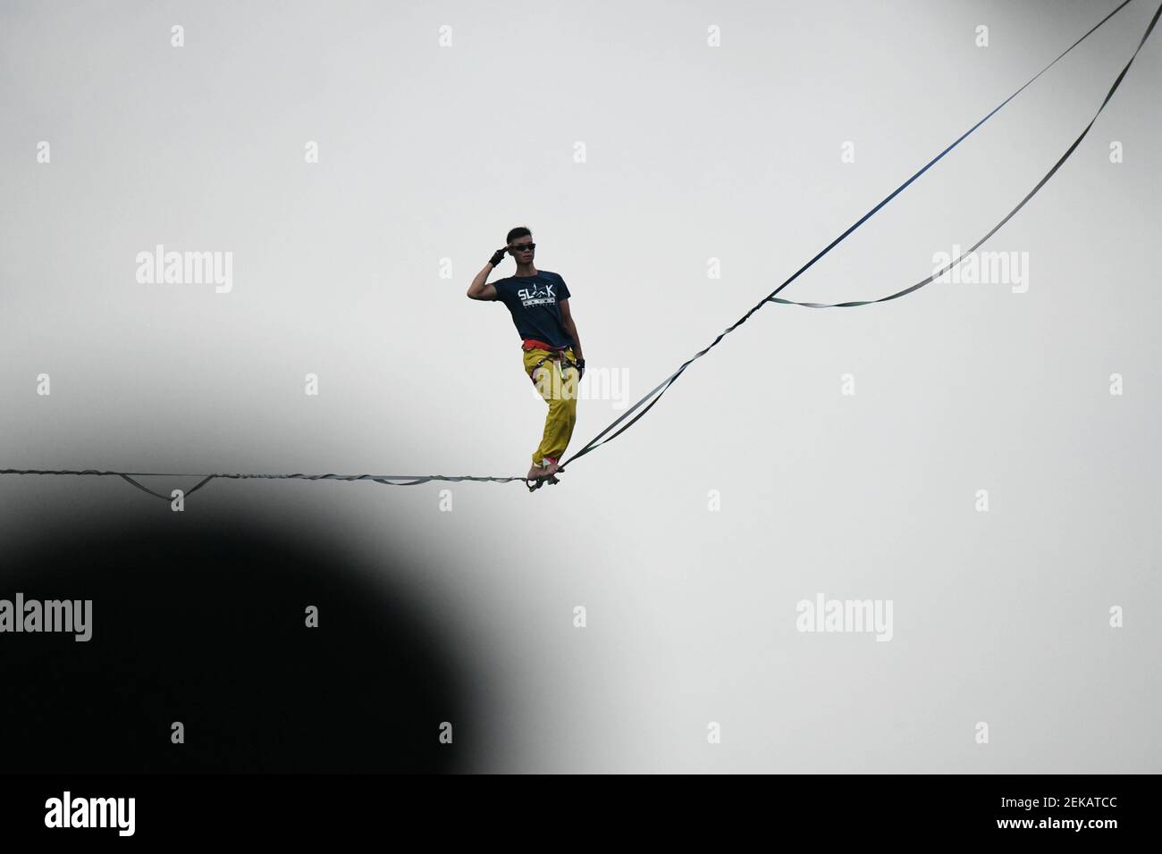 Shi Hailin, who is praised as the best slackliner in Asia, performs ...
