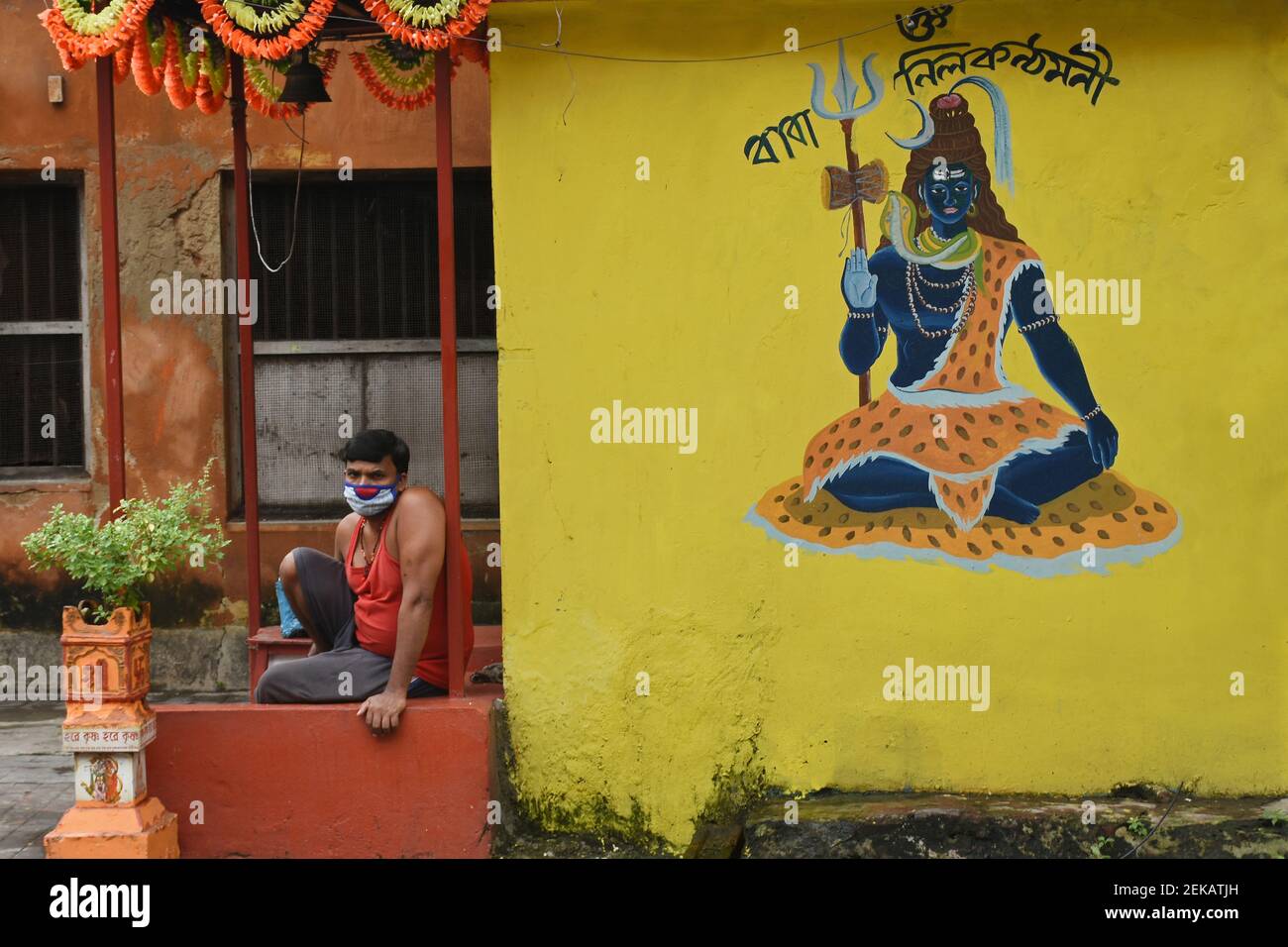 A local boy has seated at a street side temple during complete lock ...