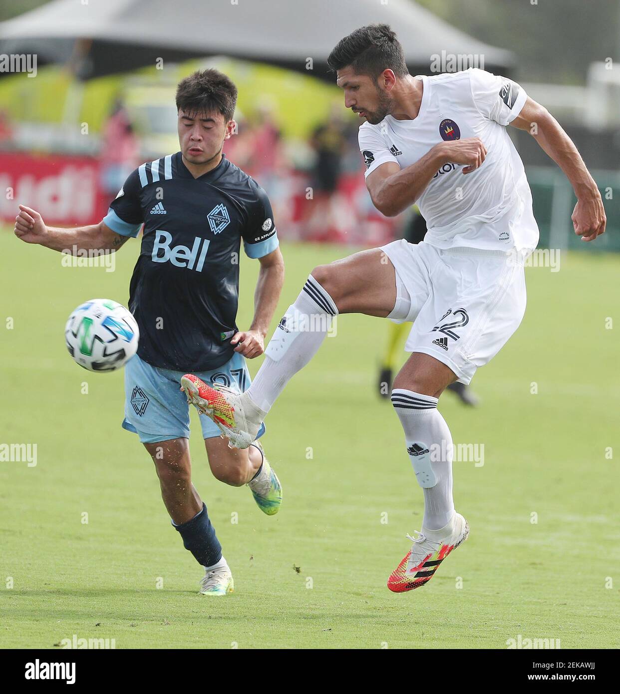 Chicago player Mauricio Pineda (22) kicks in front of Vancouver player ...