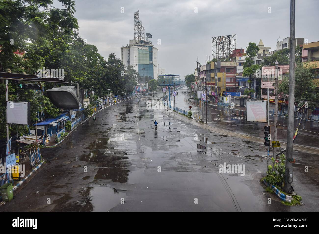 A cyclist rides on empty road during the lockdown. Chief Minister of ...