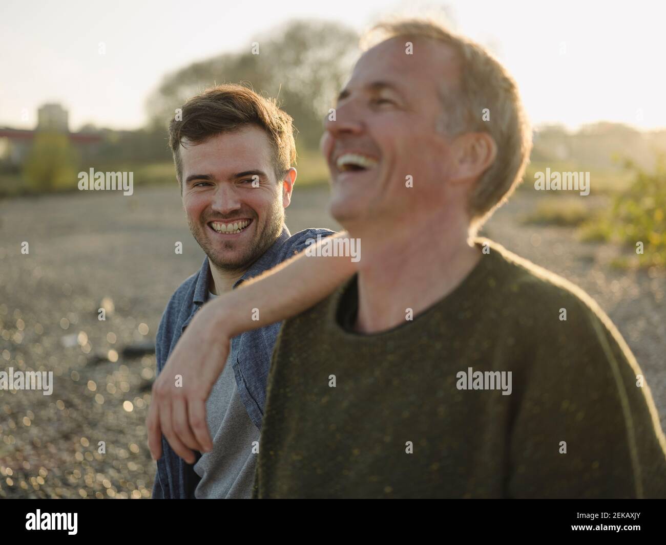 Father and son laughing at riverbank Stock Photo - Alamy