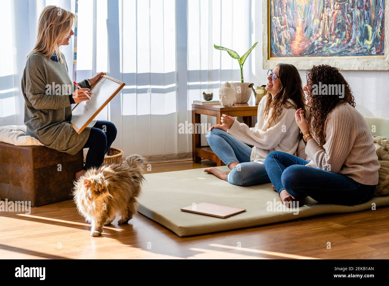 Female patients laughing during motivation session with therapist at ...