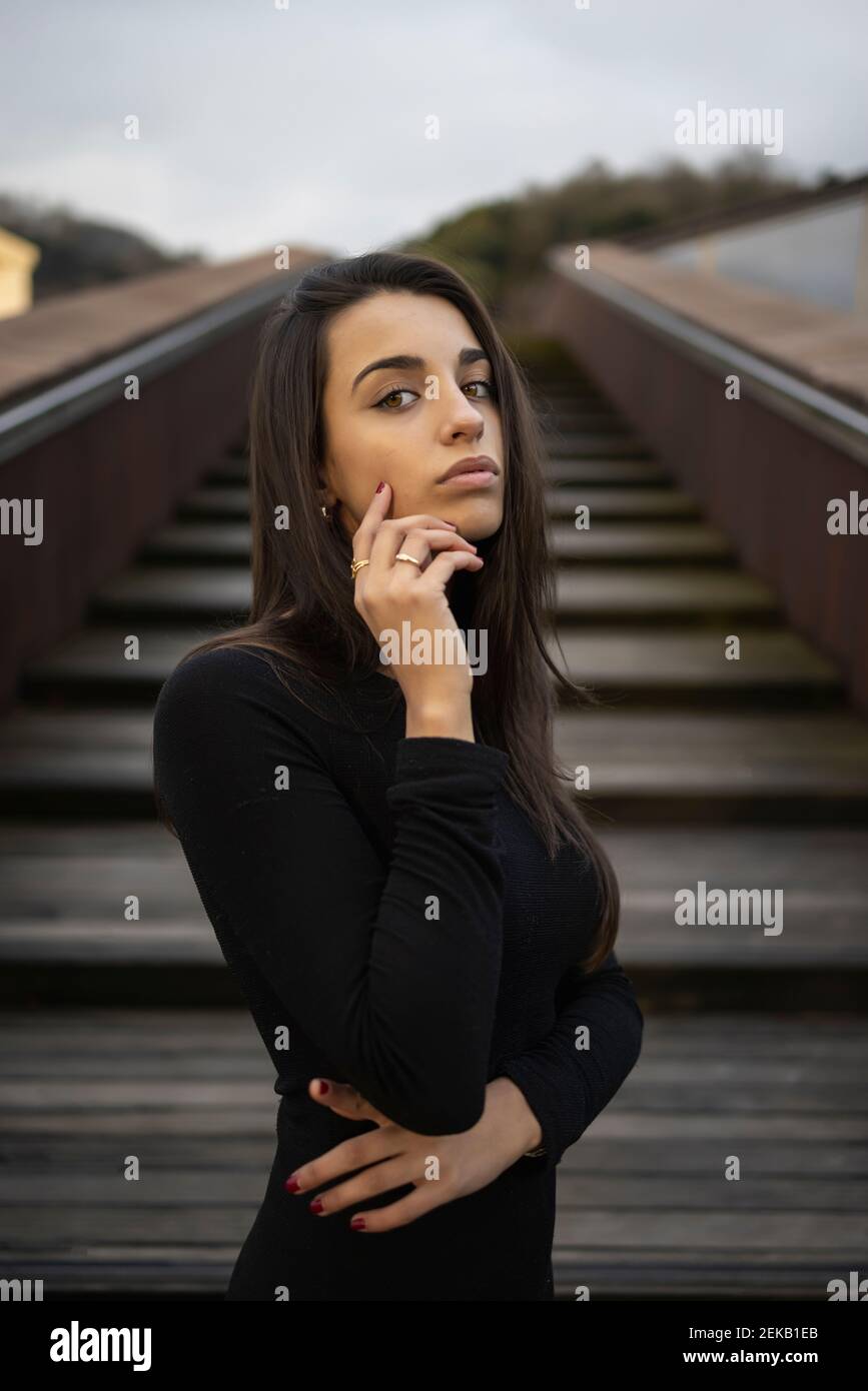 Attractive woman standing on steps Stock Photo - Alamy