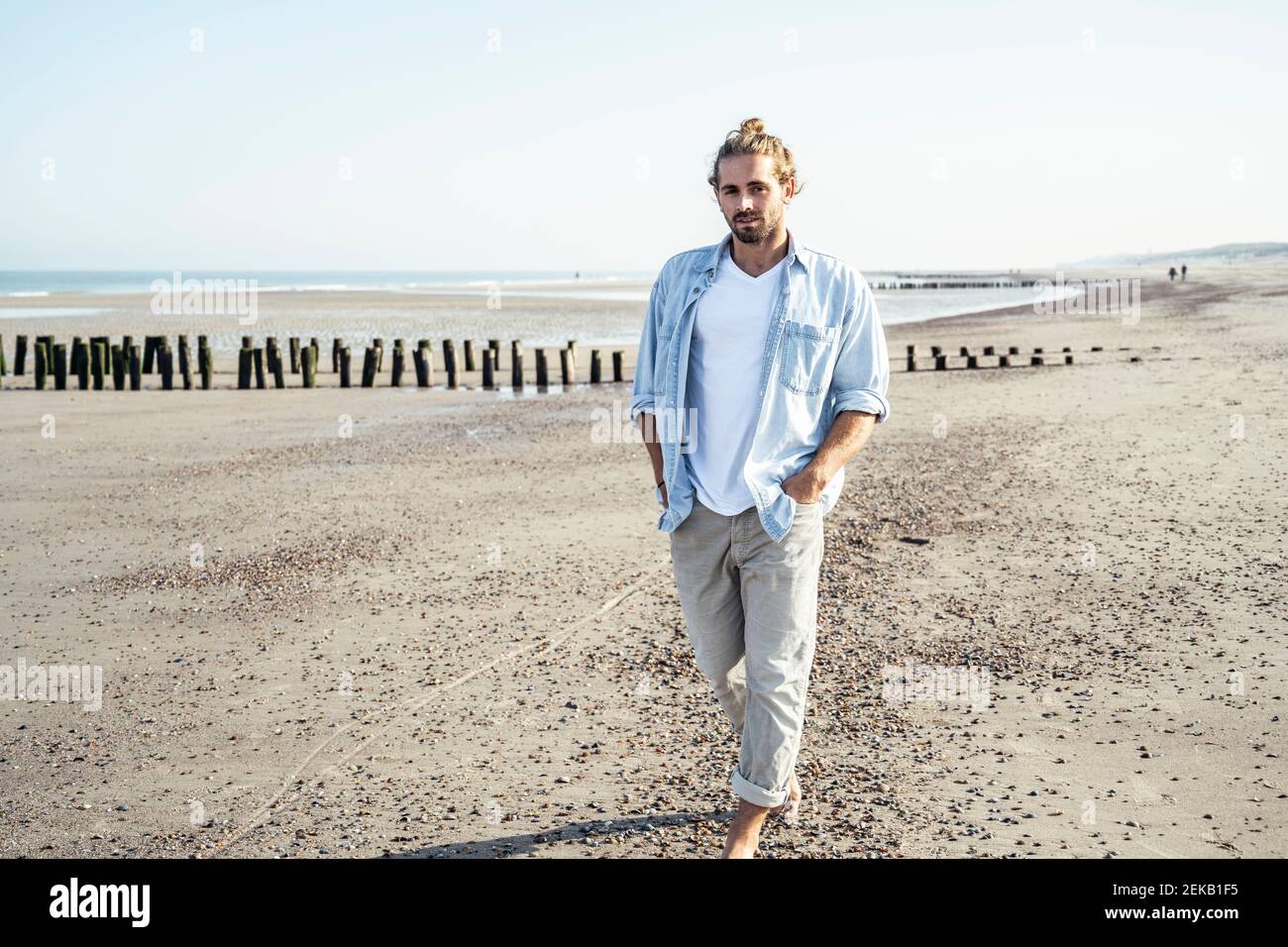 Man walking on beach hi-res stock photography and images - Alamy