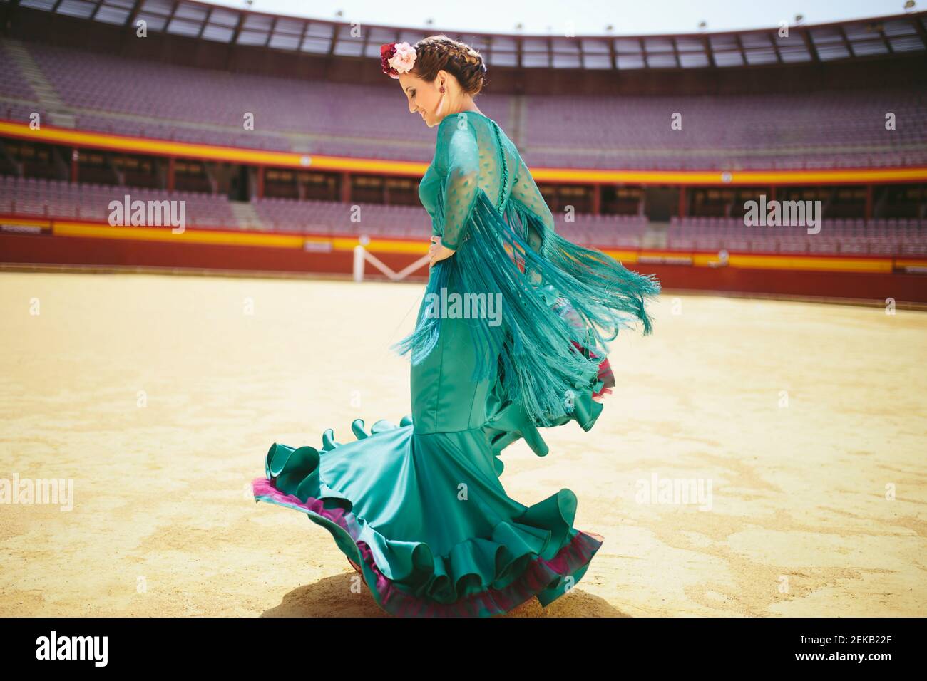 Young woman wearing blue dress flamenco dancing in bullring Stock Photo ...