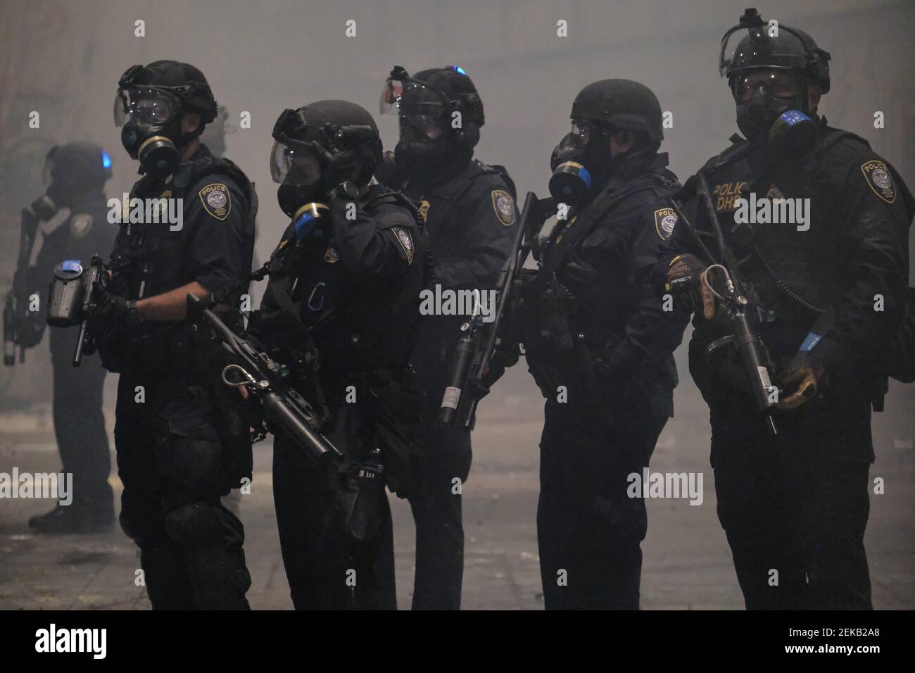 Federal officers stand out front of the federal courthouse in Portland ...