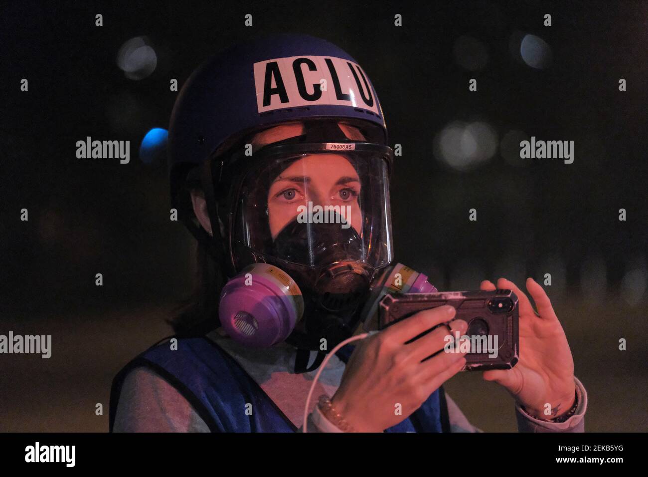 An ACLU legal observer films the scene as federal officers launch crowd ...