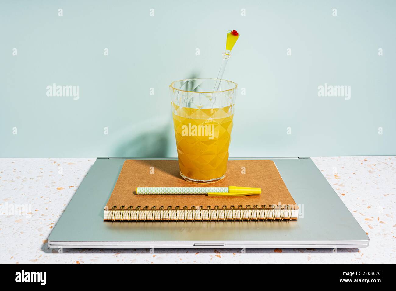 Healthy orange juice, book, pen and laptop on desk at home Stock Photo ...