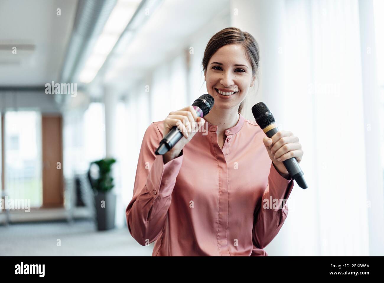 Smiling into microphone hi-res stock photography and images - Alamy