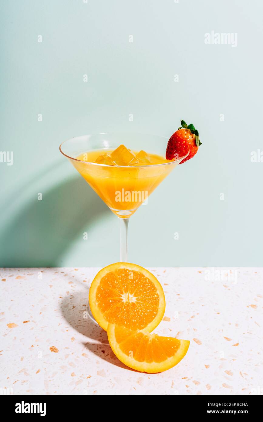 Healthy orange juice on terrazzo marble against wall Stock Photo - Alamy