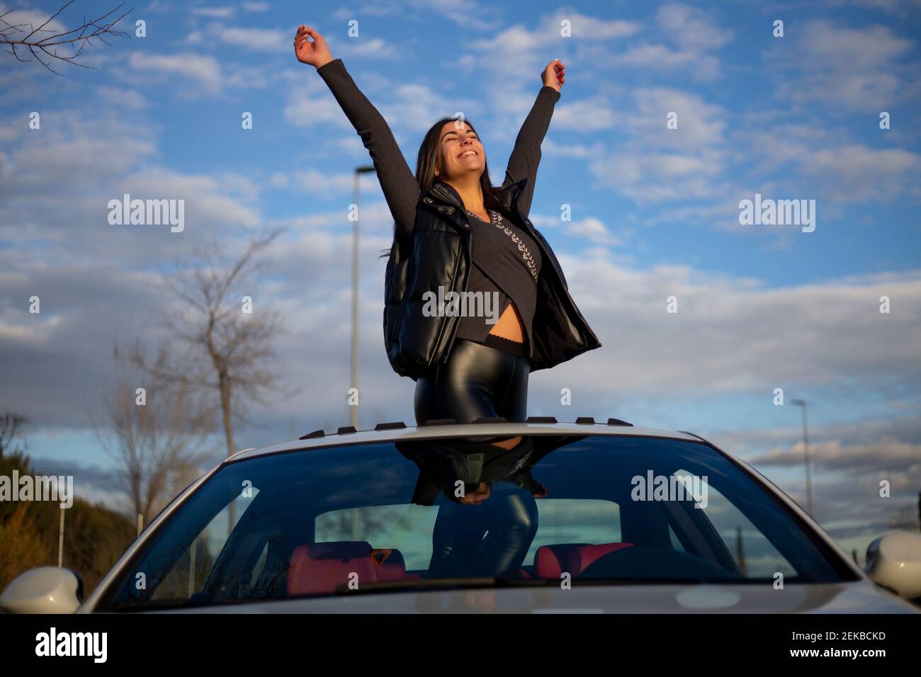 Woman standing on roof car hi-res stock photography and images - Alamy