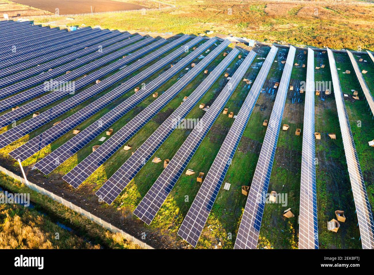 Aerial view of solar power plant under construction on green field ...