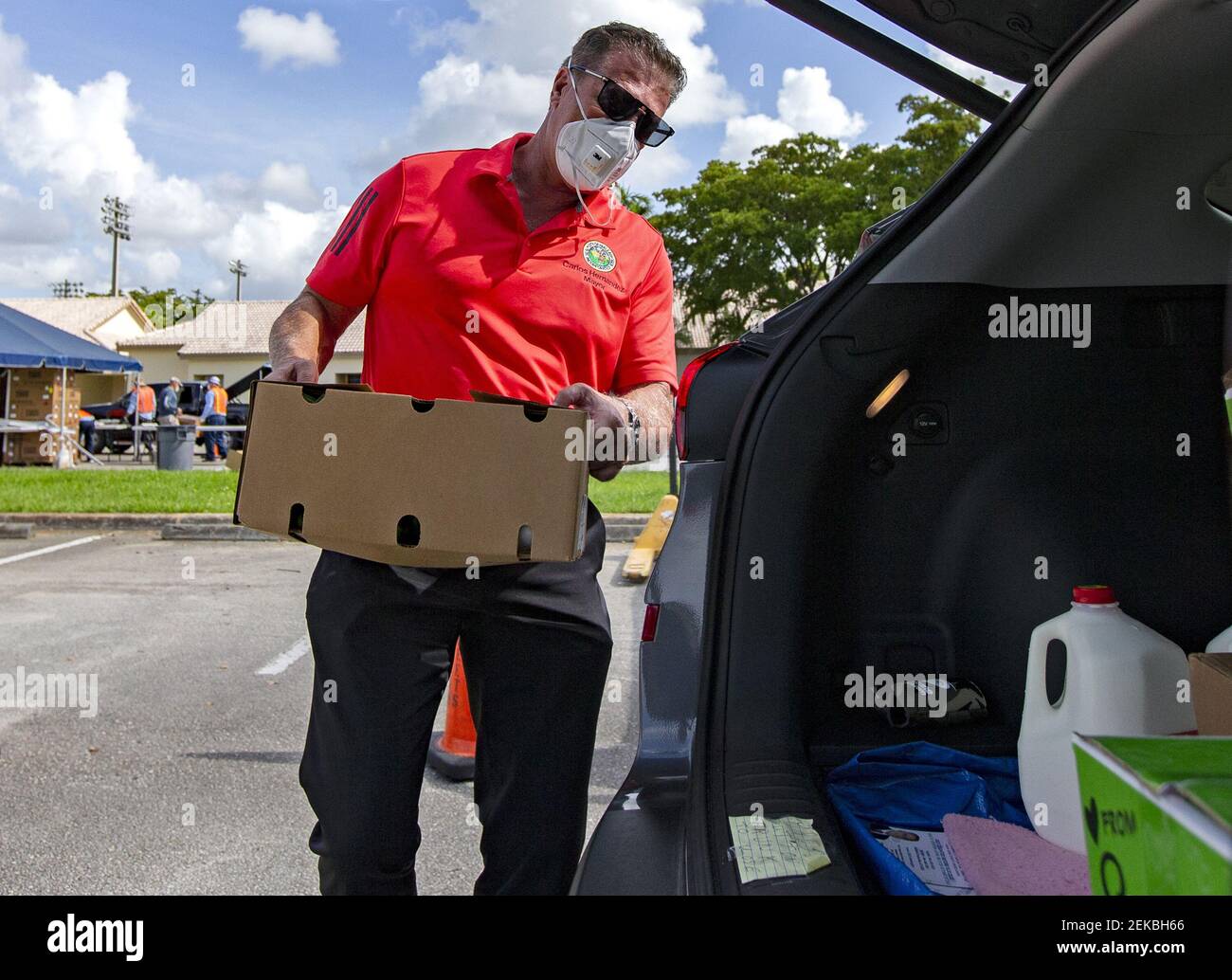 City of Hialeah Mayor Carlos Hernandez loads up food and vegetables to ...