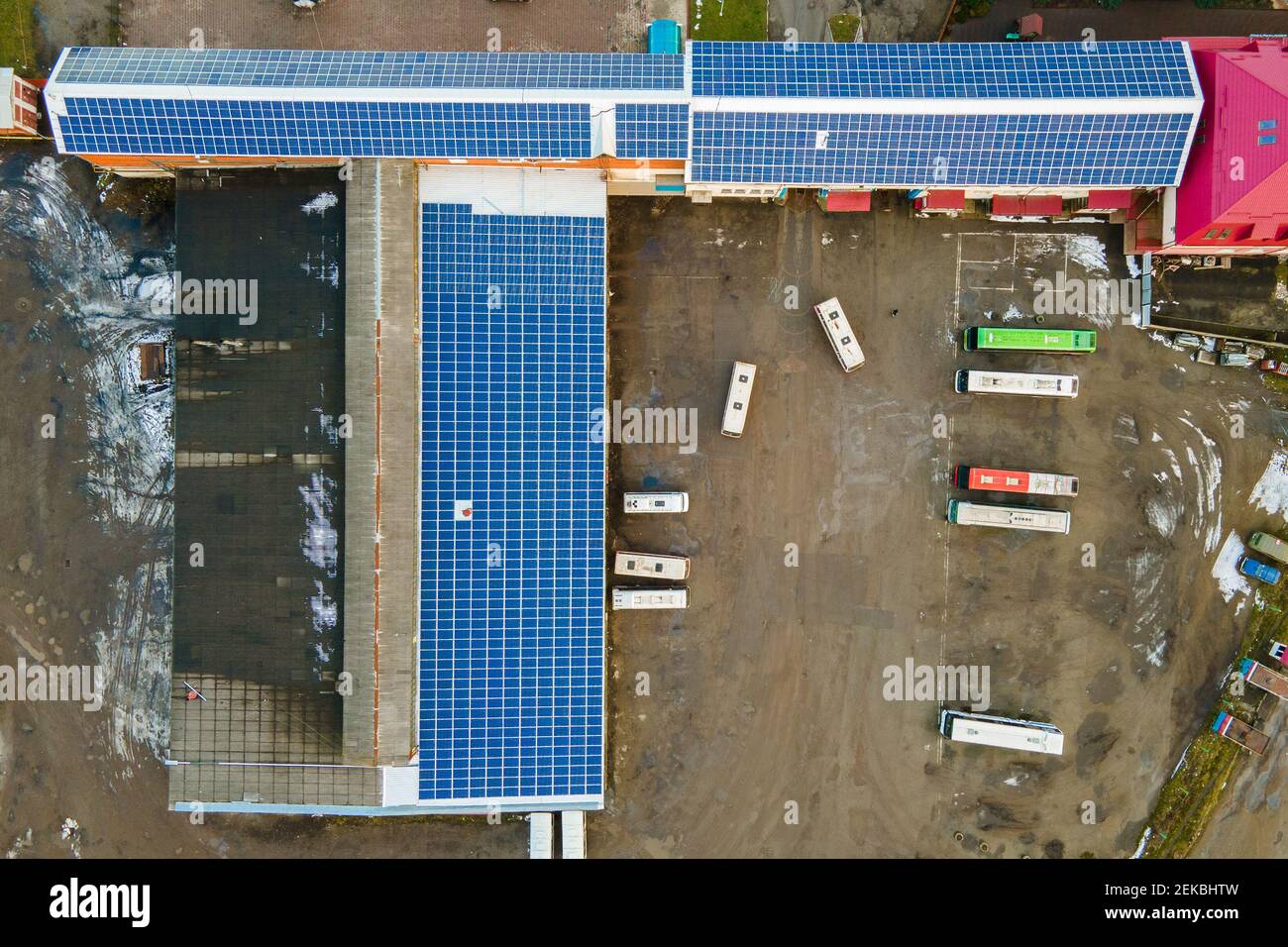 Blue photovoltaic solar panels mounted on industrial building roof for ...