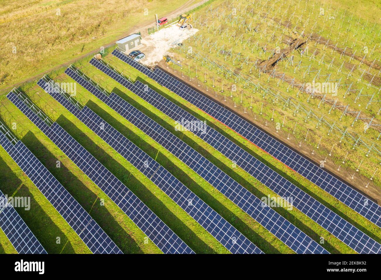 Aerial view of solar power plant under construction on green field ...