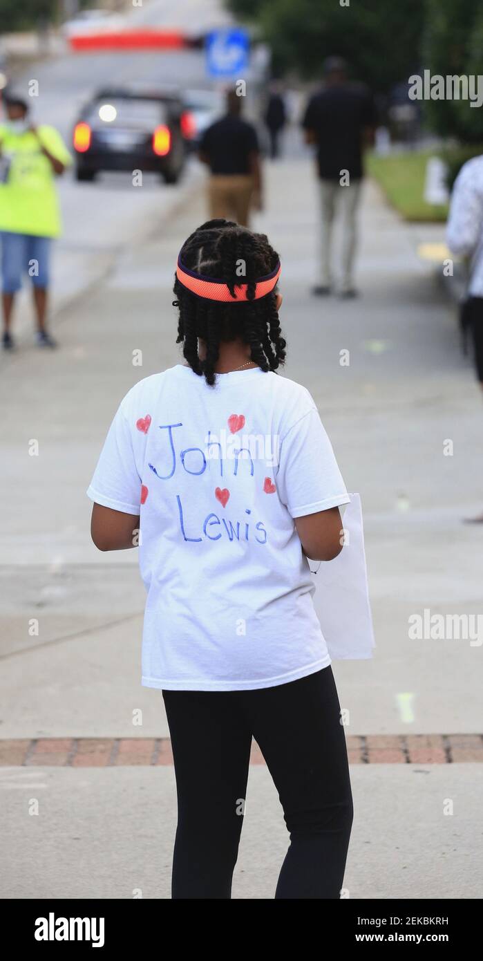 Maya Nelson, 10, wears a John Lewis t-shirt on the day of his funeral ...