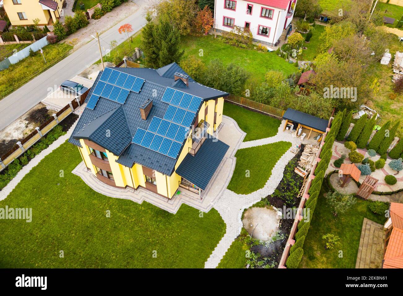 Aerial view of a private house with solar photovoltaic panels for ...