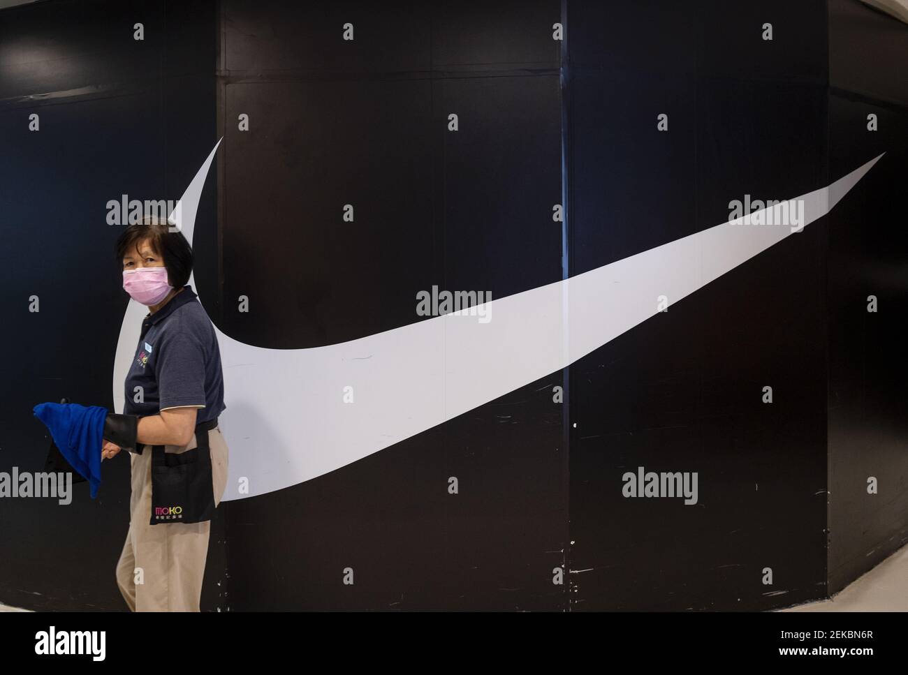 A shopping mall cleaning worker walks past an American multinational ...