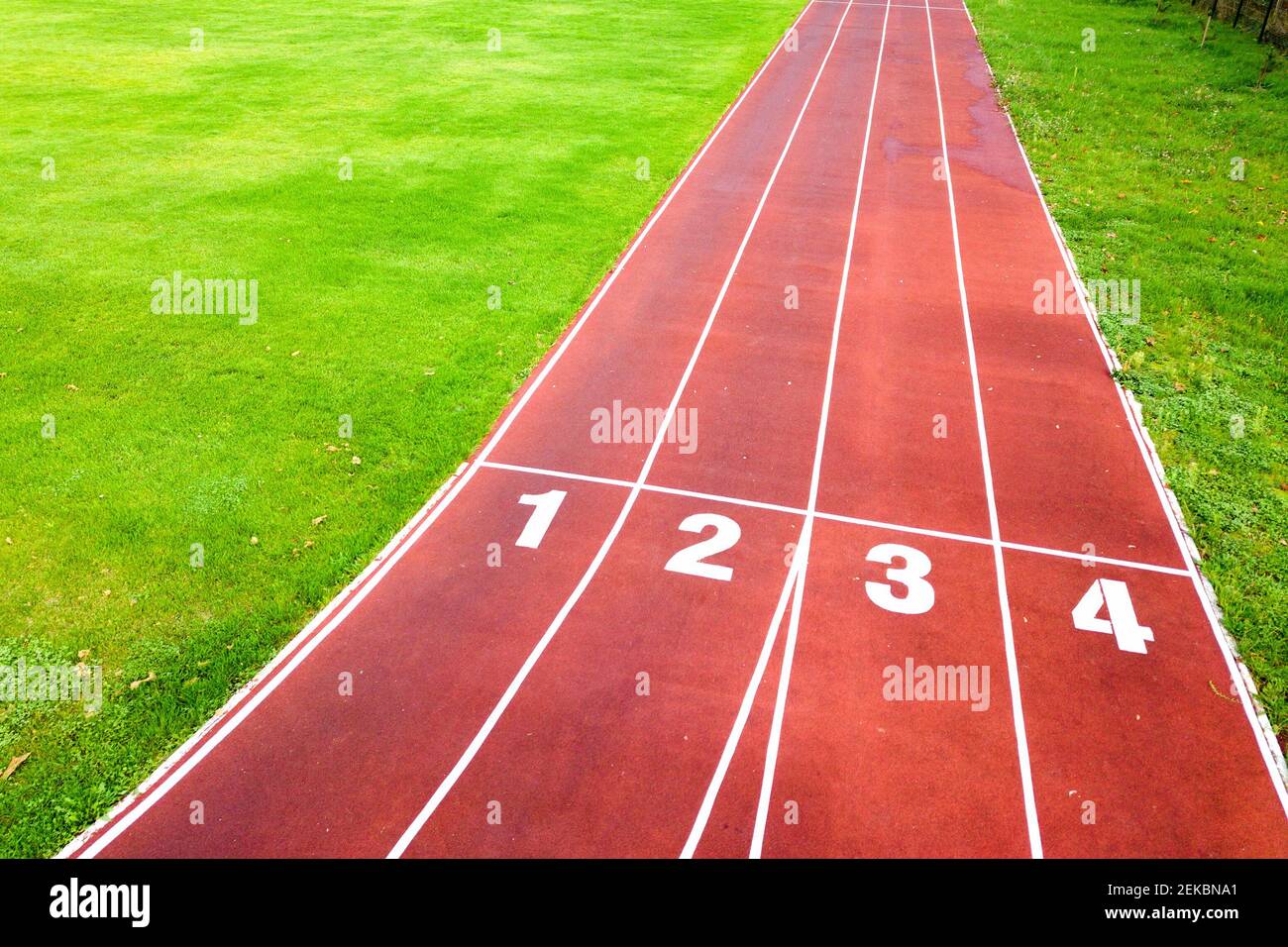 Aerial view of sports stadium with red running tracks with numbers on ...