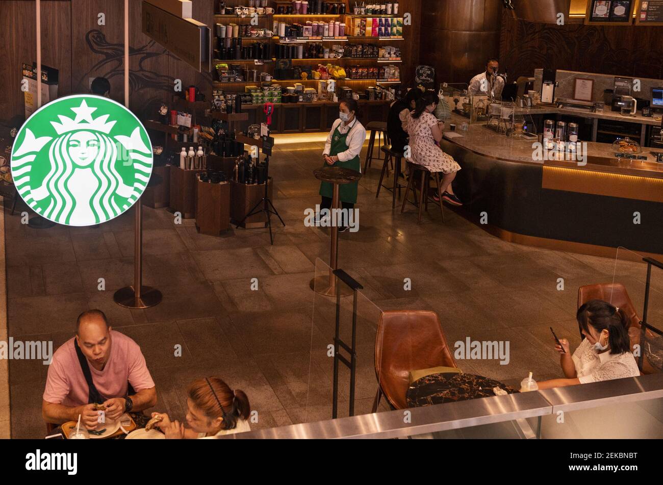 An American multinational chain, Starbucks Coffee logo and store seen ...