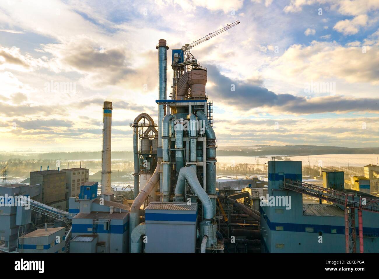 Aerial view of cement plant with high factory structure and tower crane ...