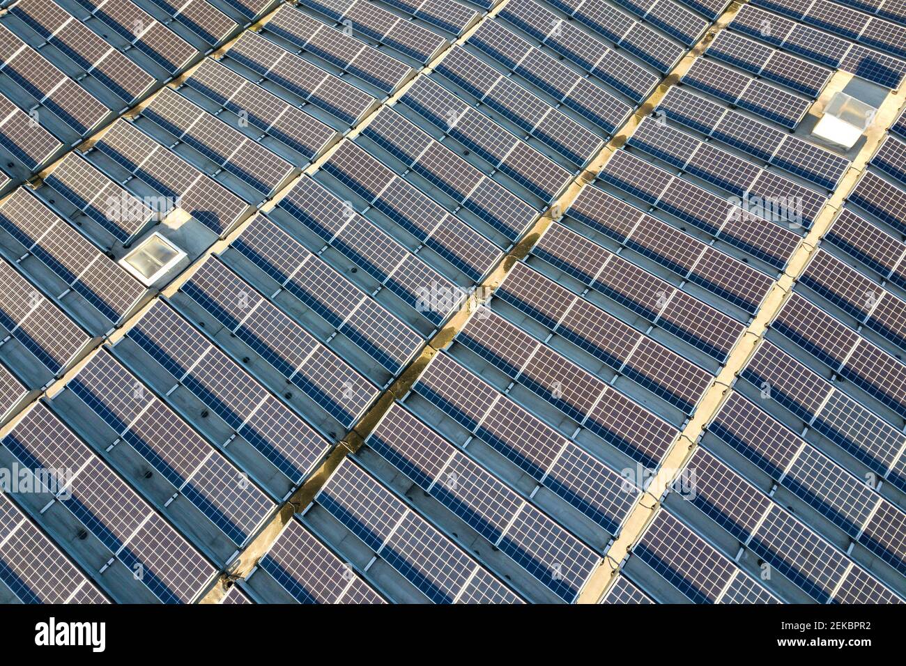 Aerial view of many photo voltaic solar panels mounted of industrial ...