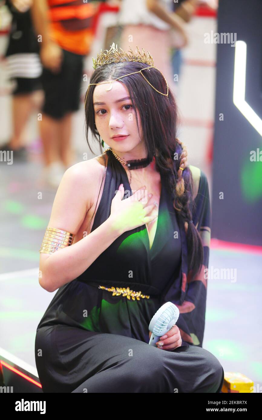 Beautiful cosplayers are seen posing and performing in clothes shown in ...