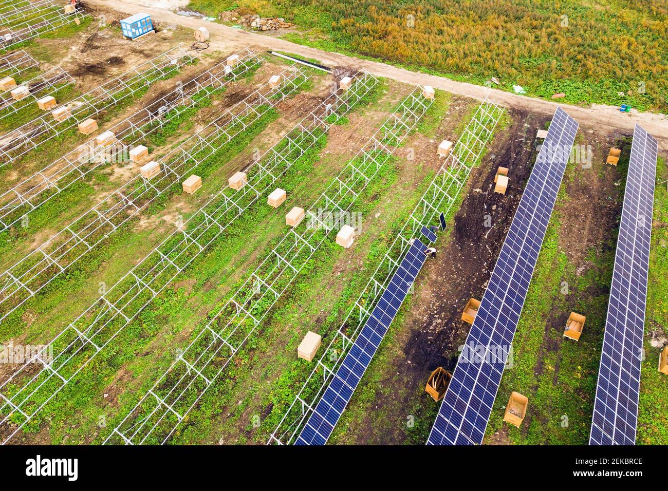 Aerial view of solar power plant under construction on green field ...