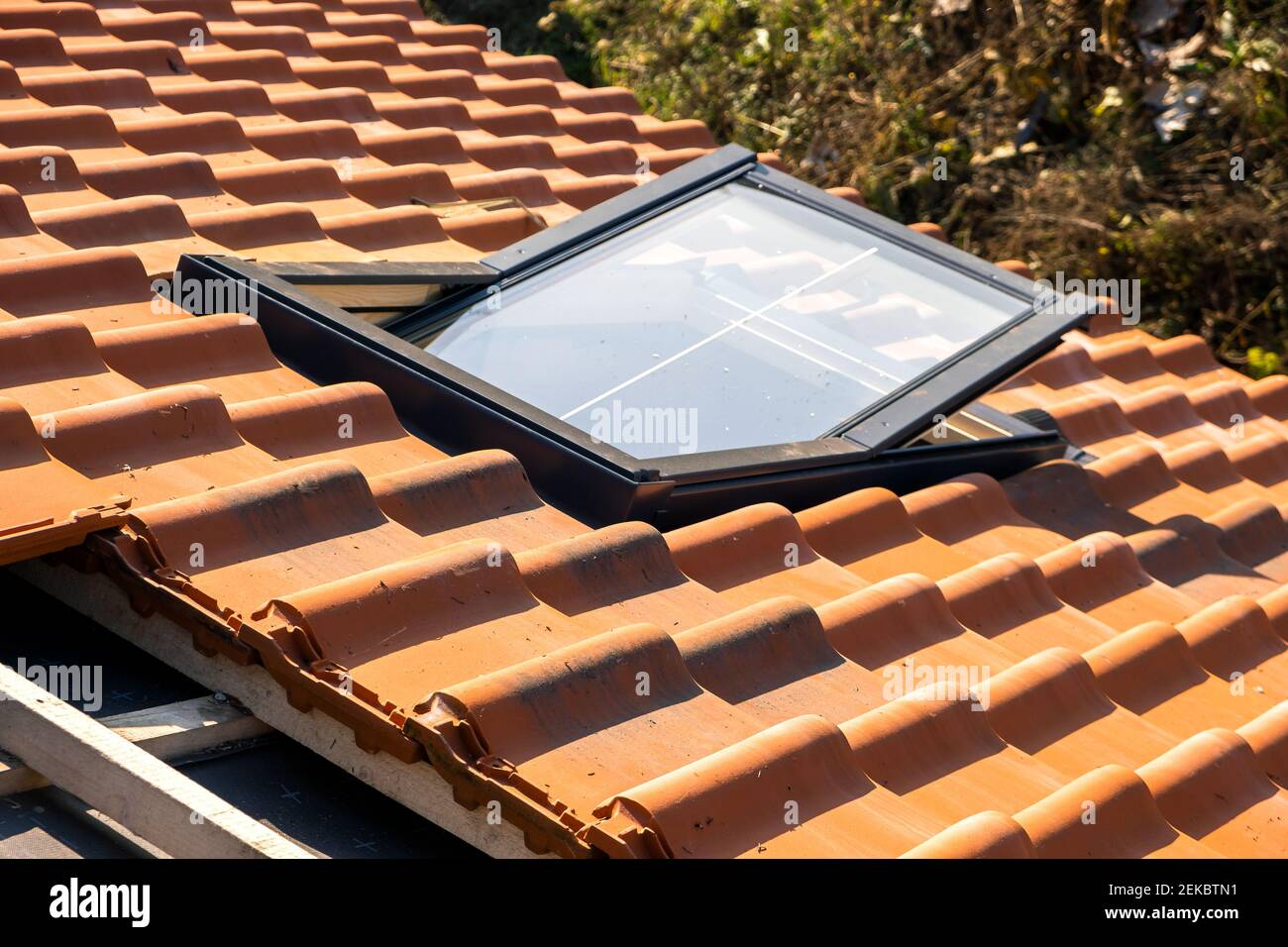 Overlapping rows of yellow ceramic roofing tiles mounted on wooden ...