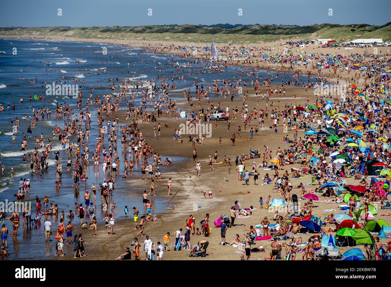 Crowds of people enjoy the sun and the warm weather during the heat ...
