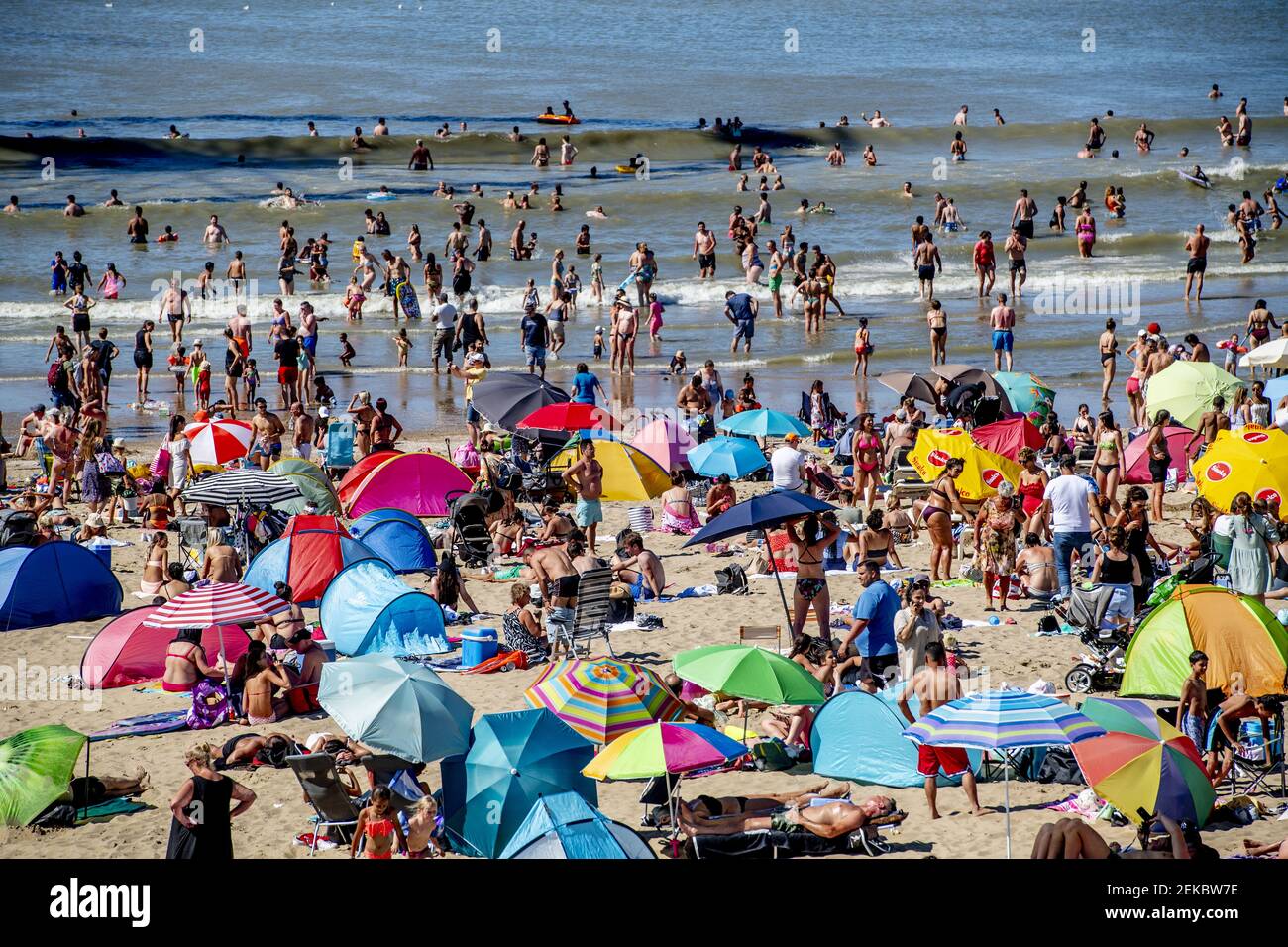 Crowds of people enjoy the sun and the warm weather during the heat ...