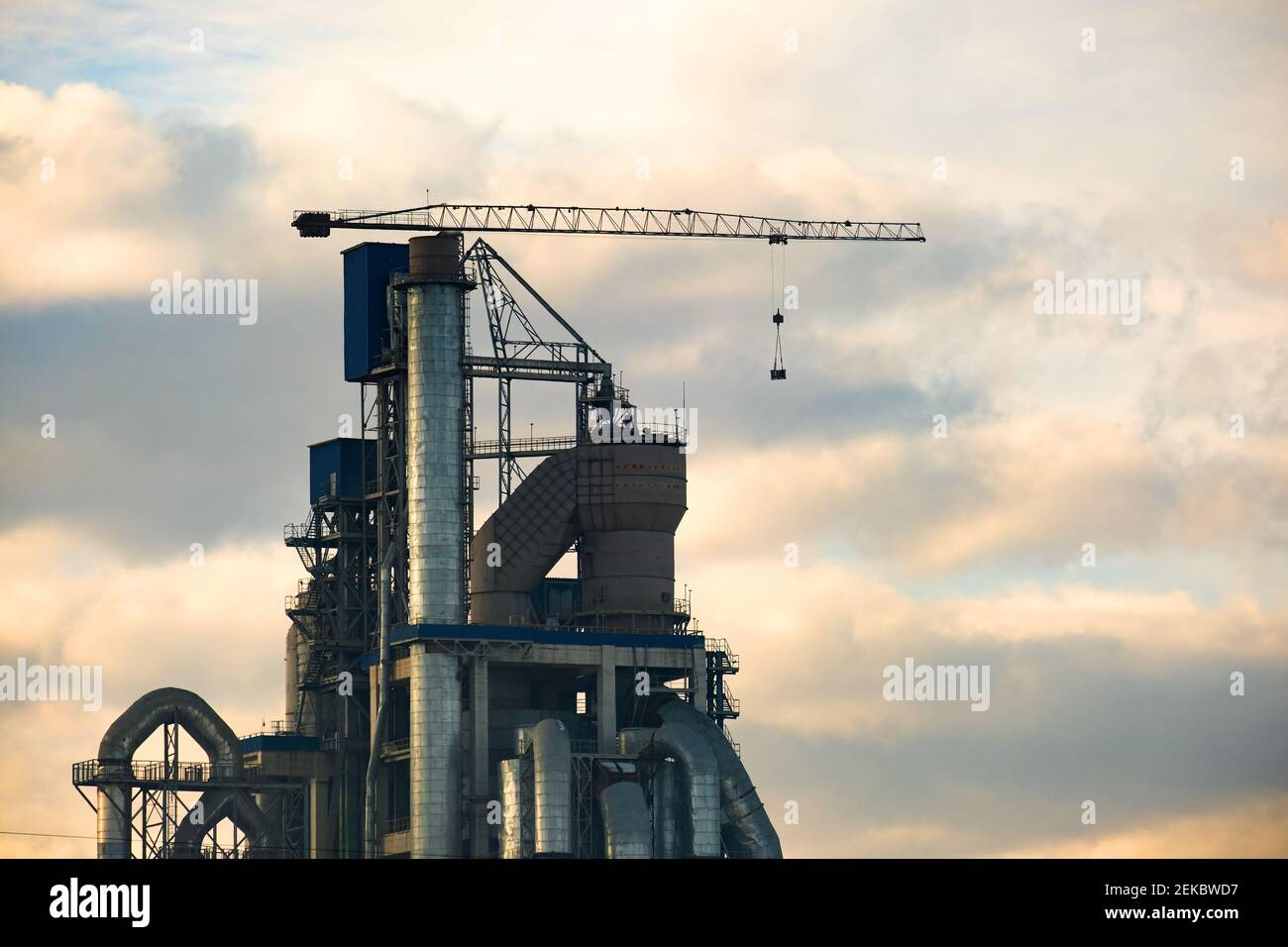 Cement plant with high factory structure and tower crane at industrial ...