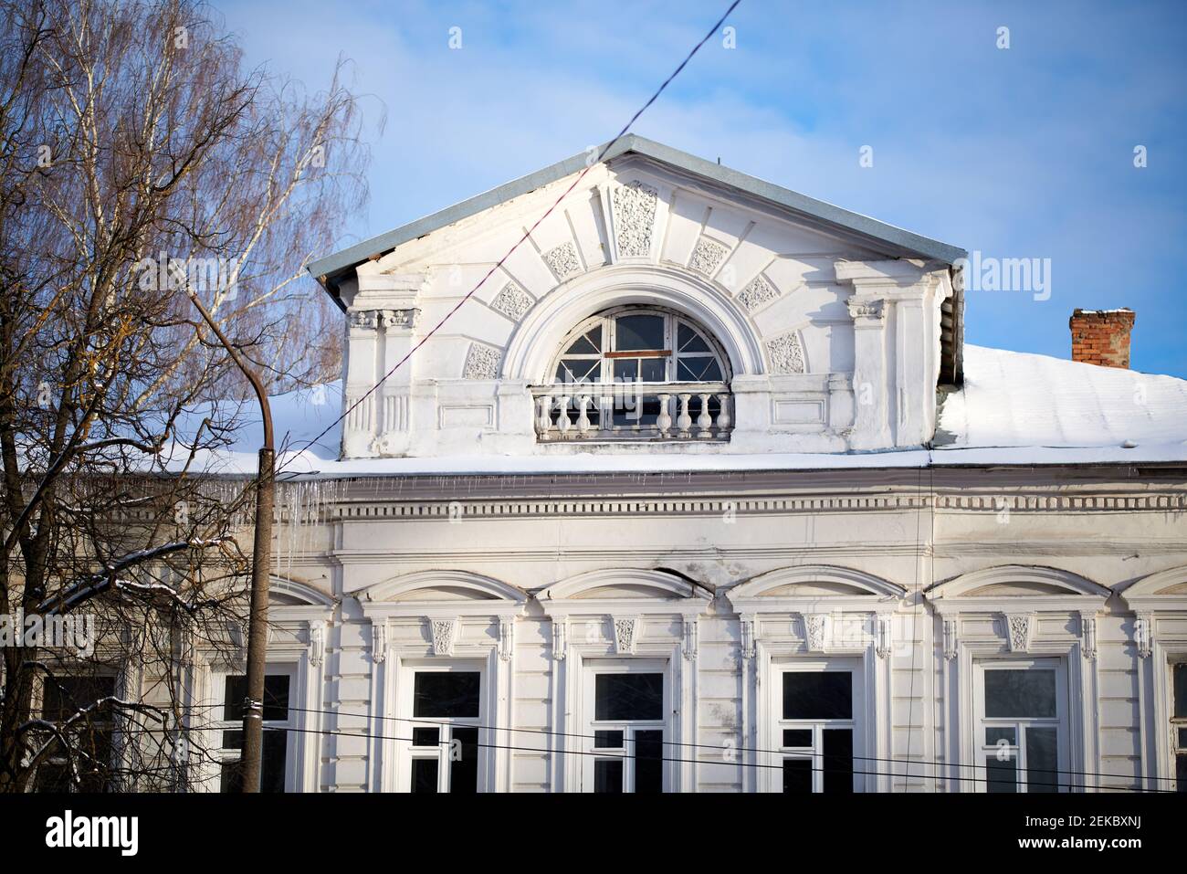 Attic with white balusters on the roof of a white house Stock Photo - Alamy