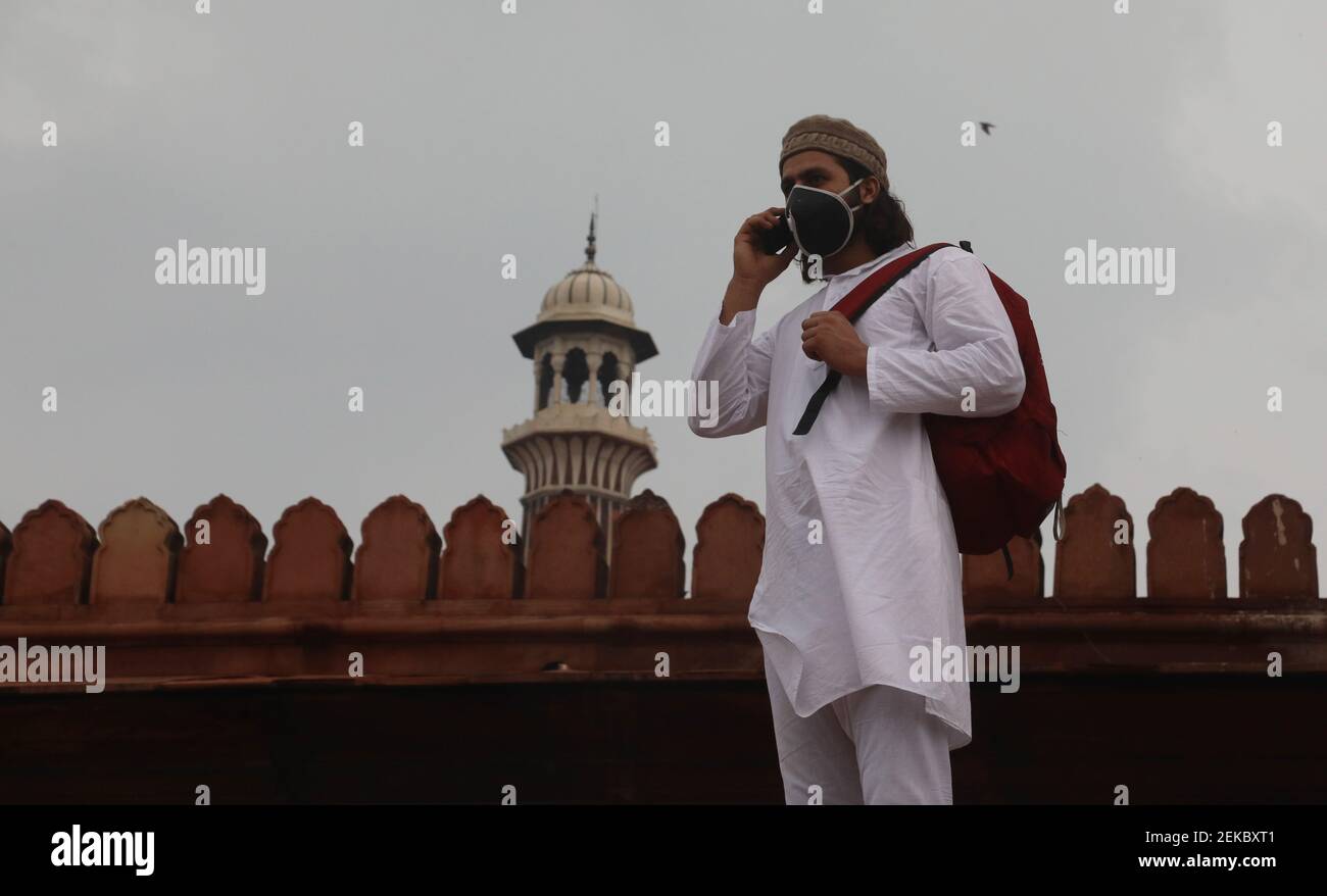 A Muslim man wearing a face mask as a preventive measure leaves after ...