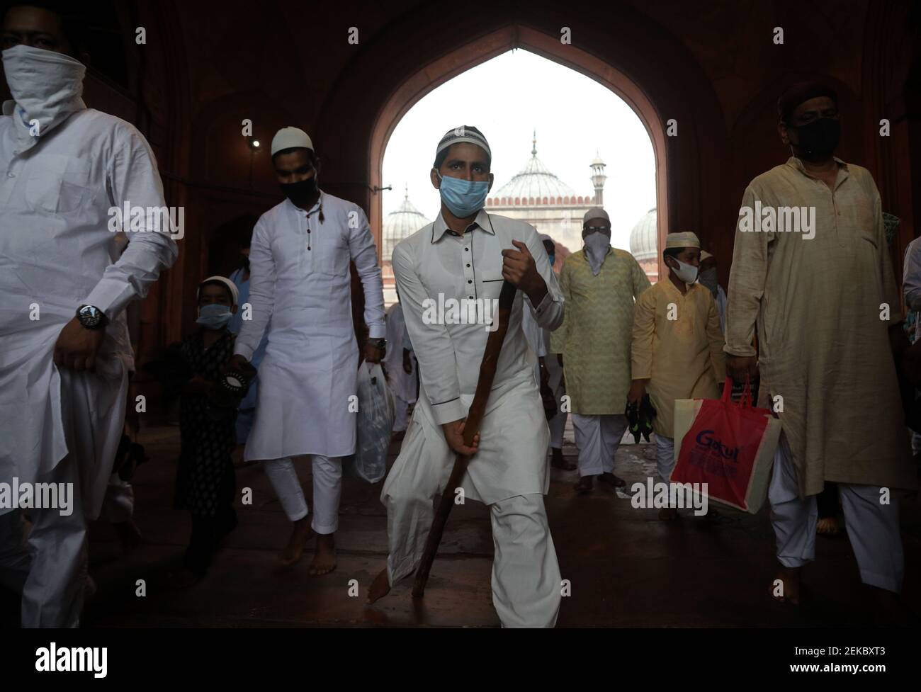 Muslim people wearing face masks as a preventive measure leave after ...
