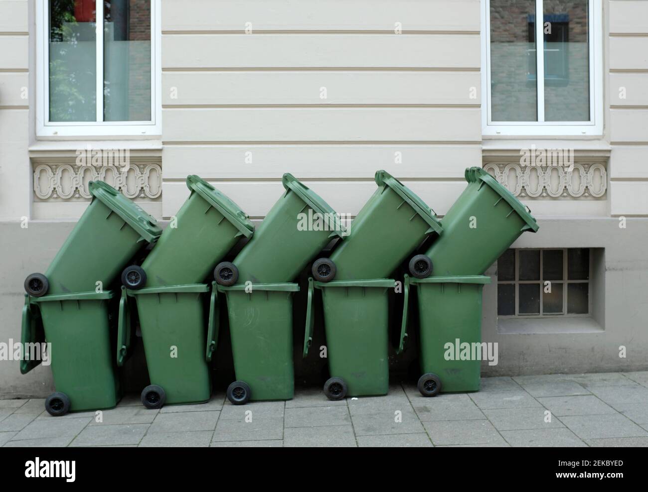 Germany, Hamburg, Altona, Garbage cans piled up in residential area ...