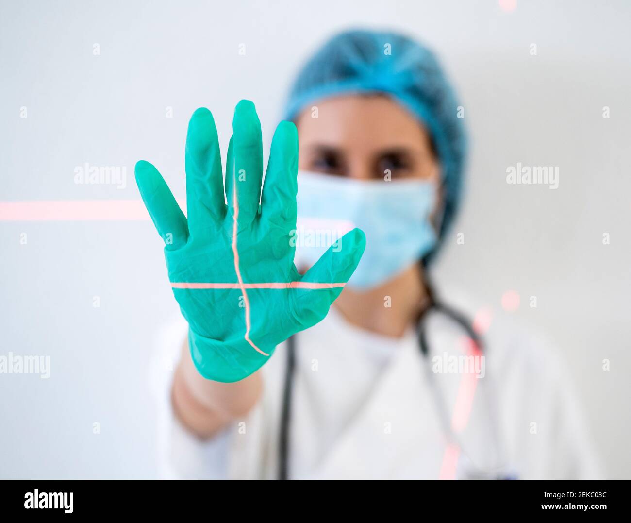 Female doctor's hand protecting face from laser light at clinic Stock ...