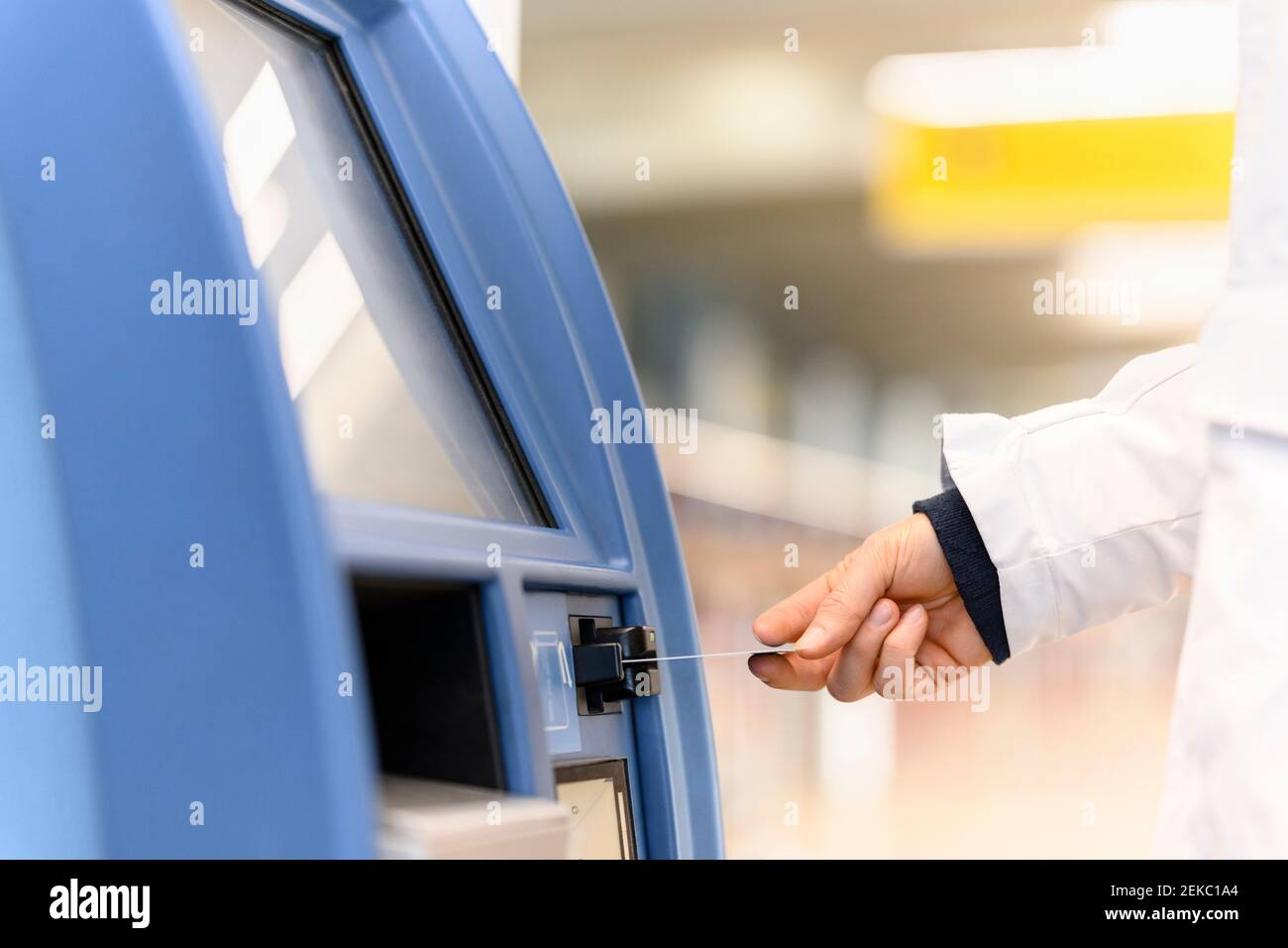 Man's hand withdrawing money at ATM machine Stock Photo - Alamy