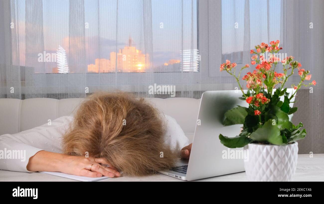Tired business woman at workplace, holding her head in hands ...